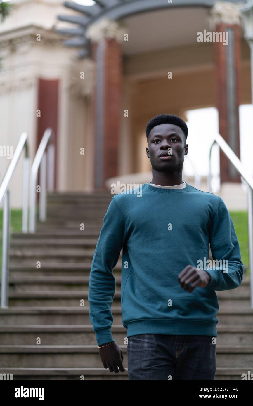 A young black man walking down the stairs of a park in Bilbao Stock ...