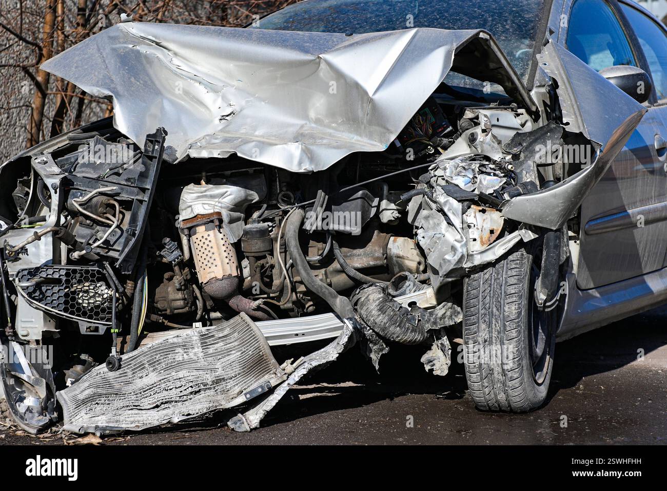 Total loss car crash showing the damaged engine after a dangerous road ...