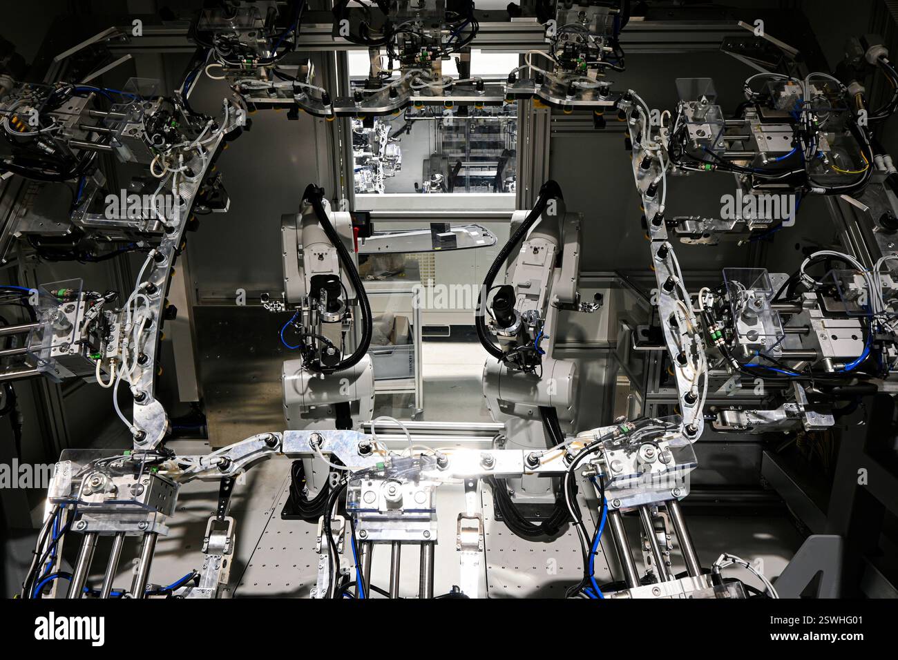 Two Robotic Arms Working Together In A Modern Automated Factory Setting Performing Precise