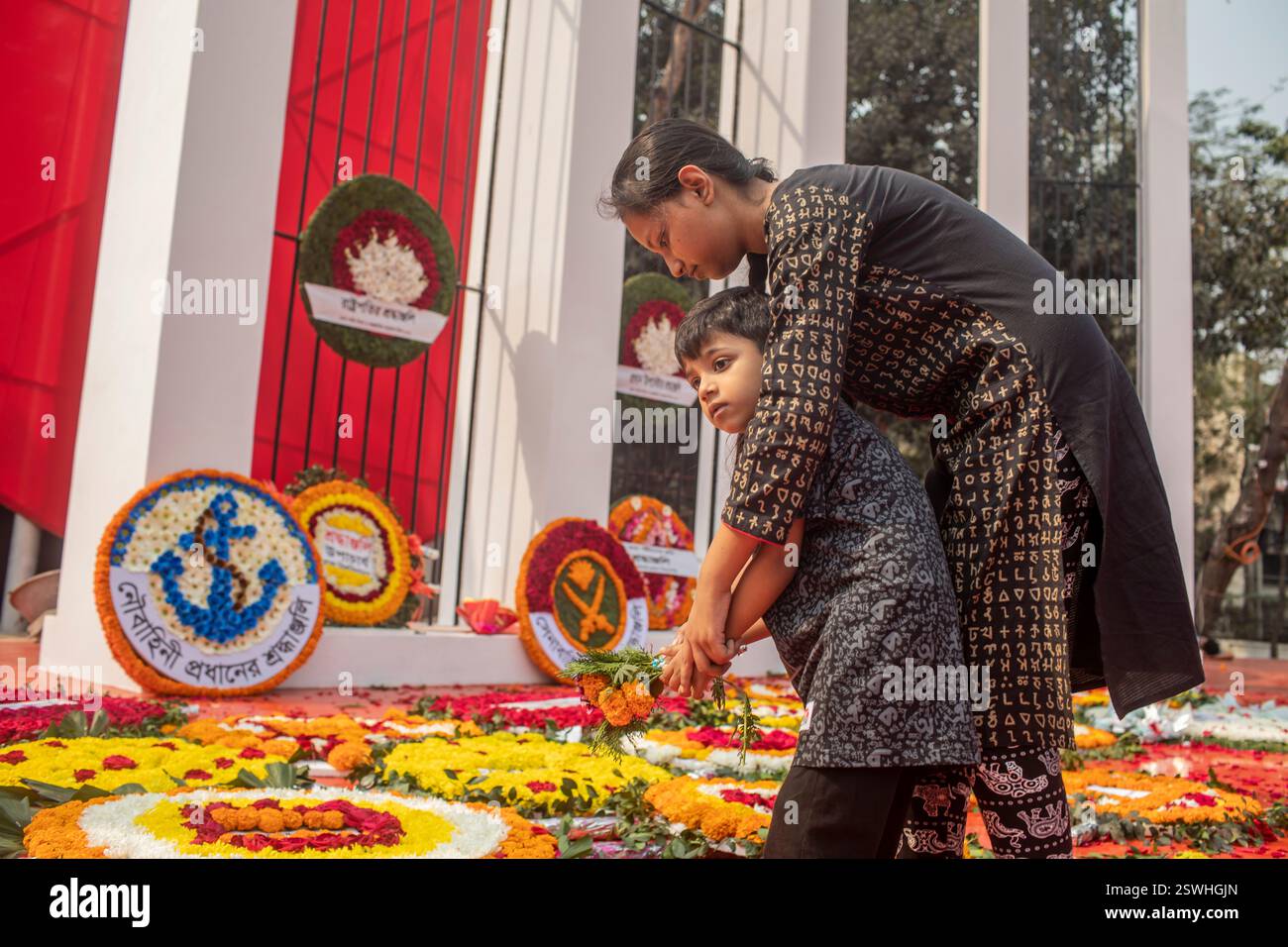 A mother and her child pay tribute at the Martyr's Monument or Shaheed ...