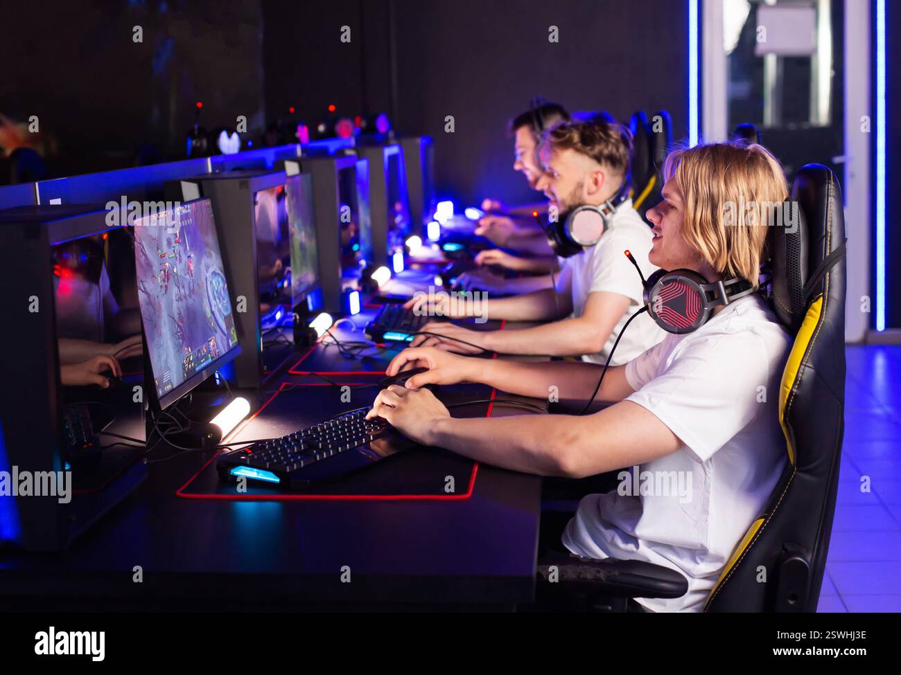 Five Caucasian gamers of different ages are playing strategy game in ...