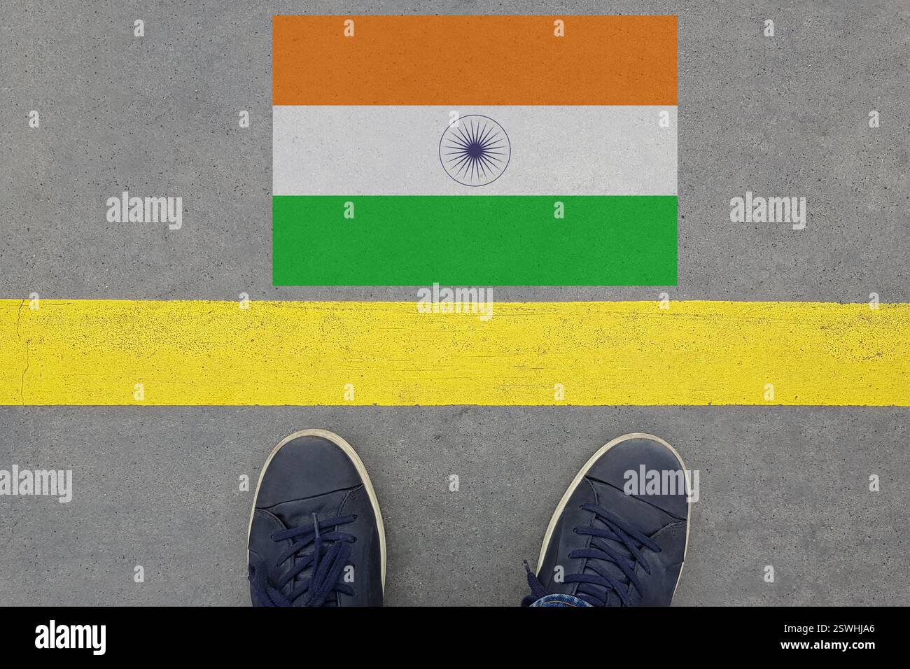 Word Start on an asphalt road with the Indian flag and legs in shoes ...