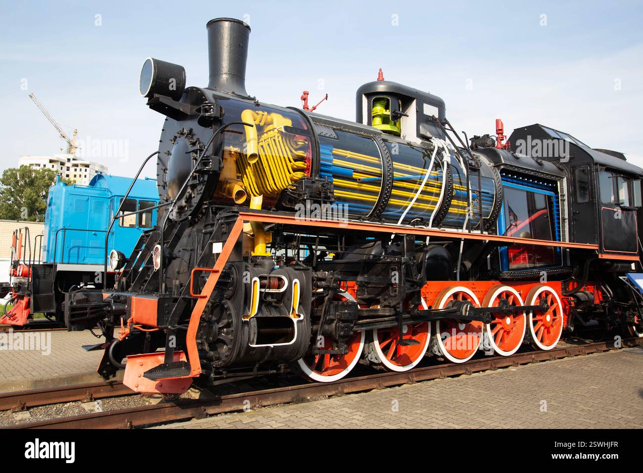Museum exhibit of a steam locomotive with multi-colored steam turbines ...
