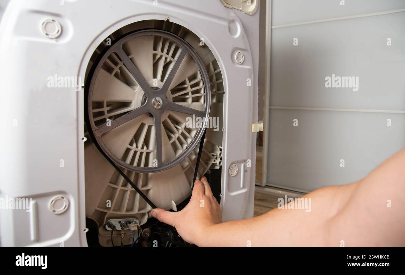checking the belt tension on the washing machine pulleys. Washing ...