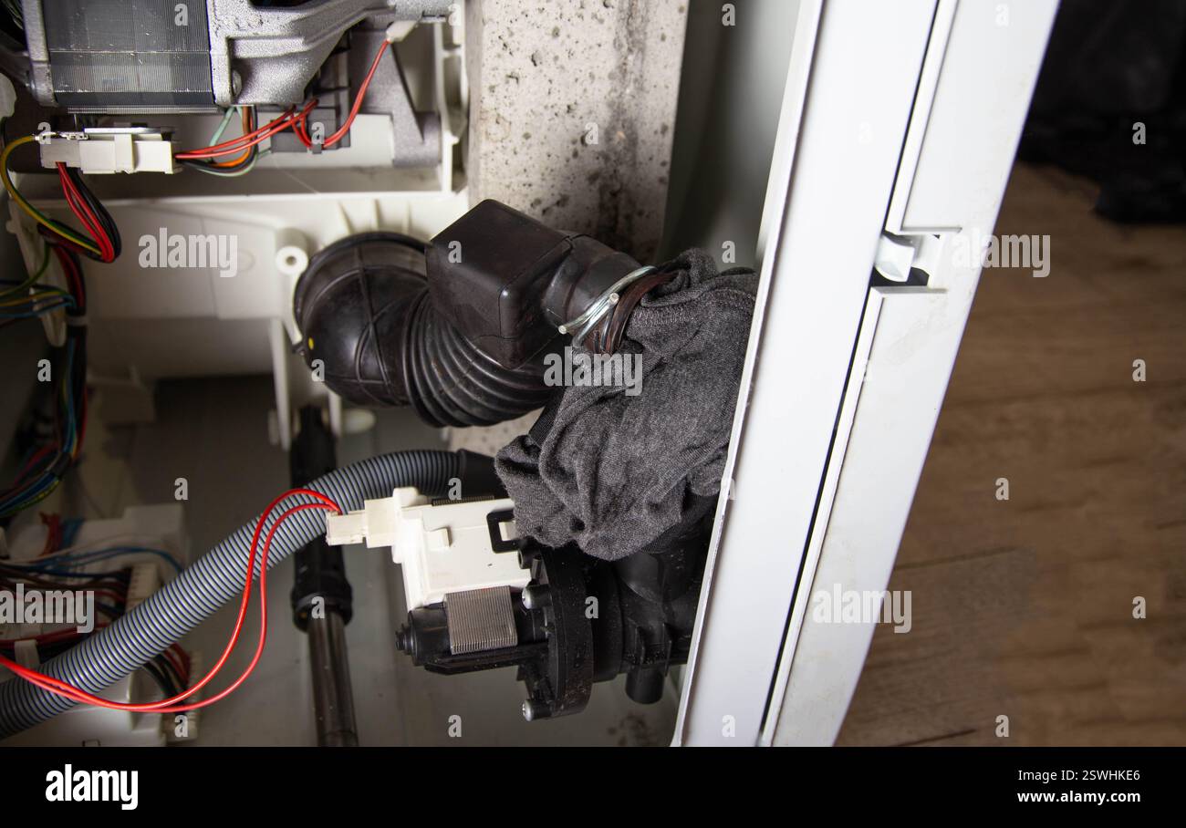 The rubber drain pipe and drain pump are clogged with clothes in the ...