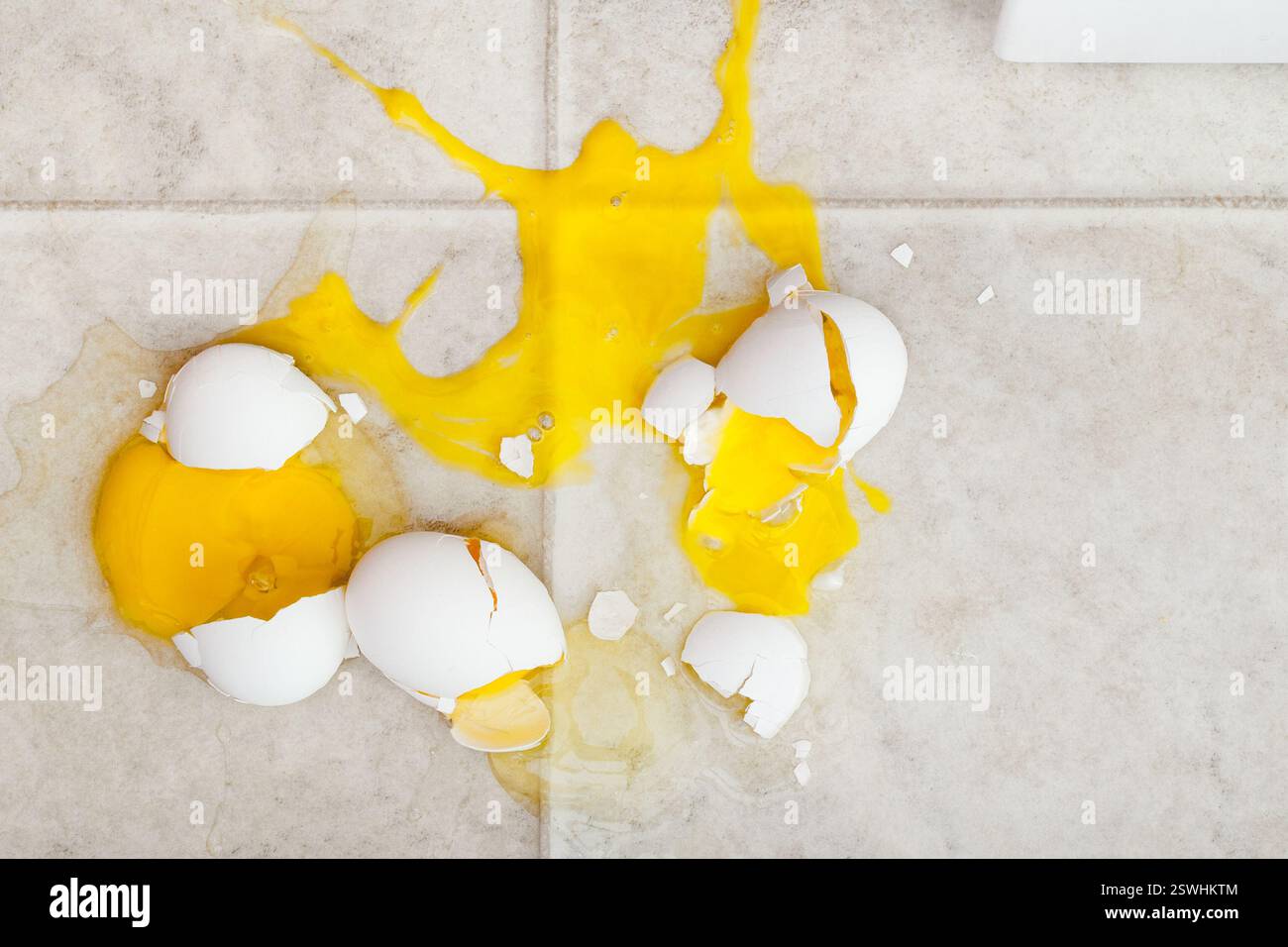 Eggs dropped on kitchen floor Stock Photo - Alamy