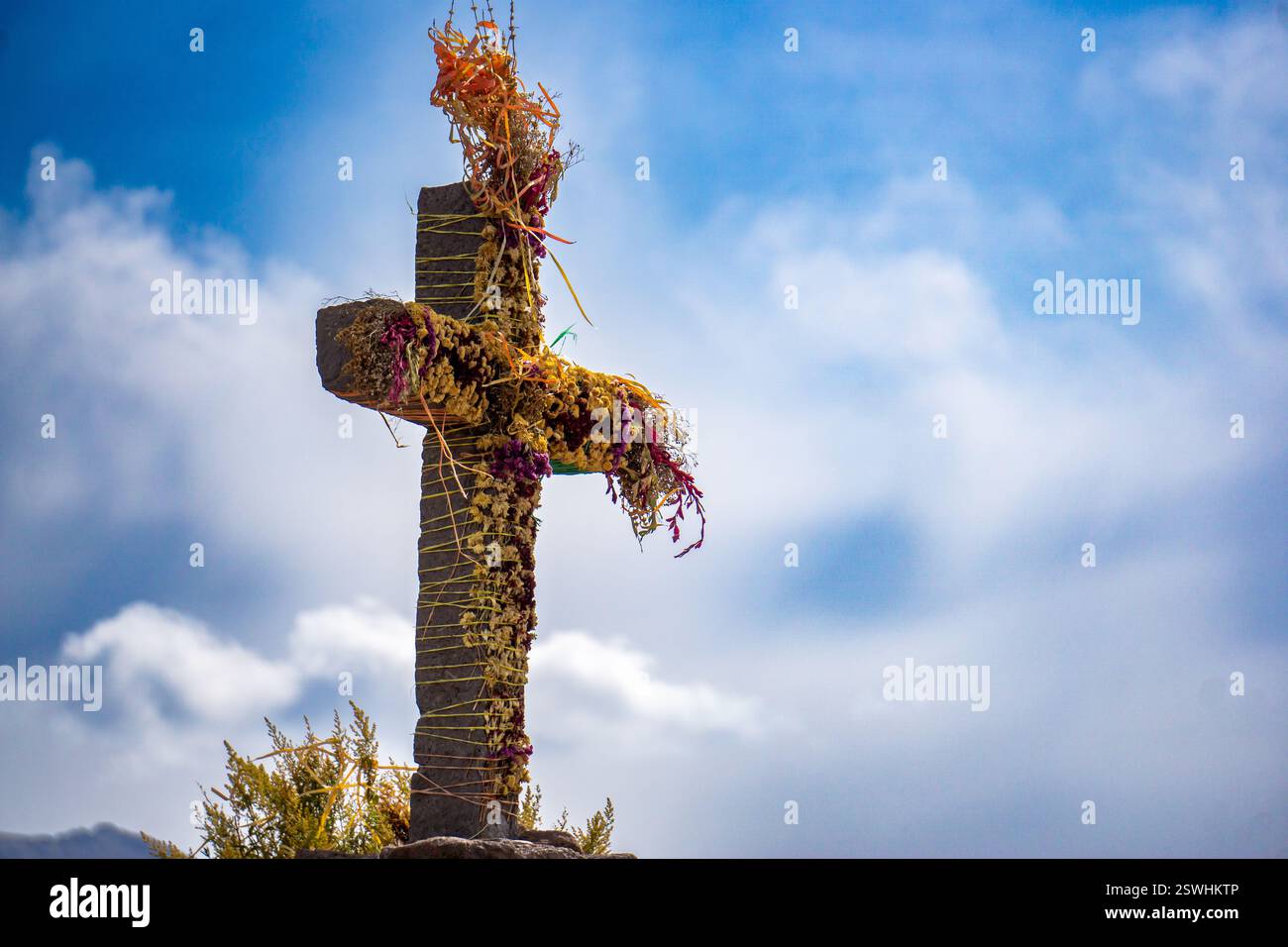 Cross with colorful flowers at Mirador del Condor in Colca Canyon Peru ...