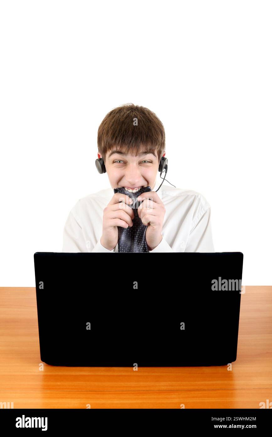 Nervous Young Man at the Desk with Laptop bite his Necktie Isolated on ...