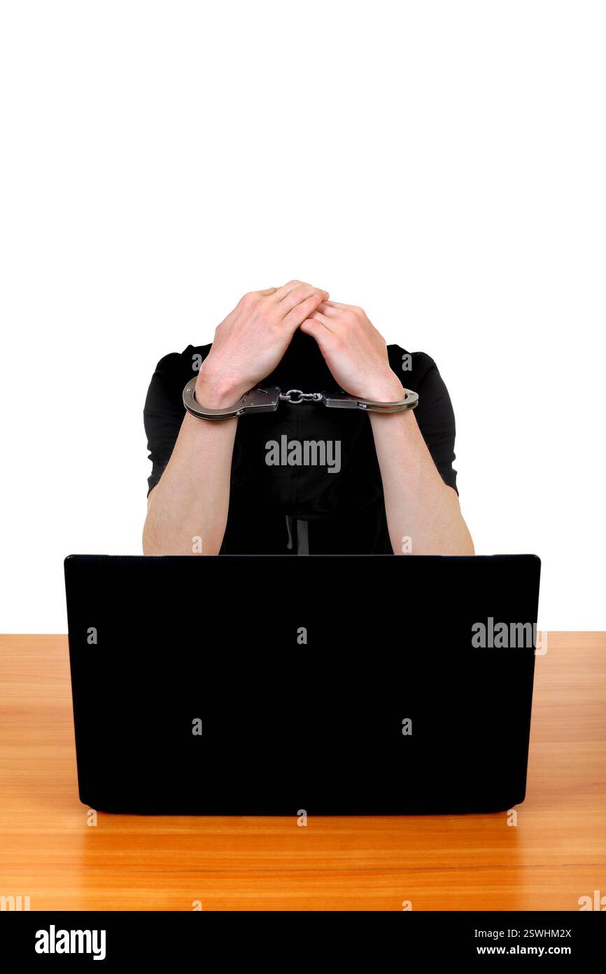 Man in Handcuffs at the Desk with Laptop Isolated on the White ...