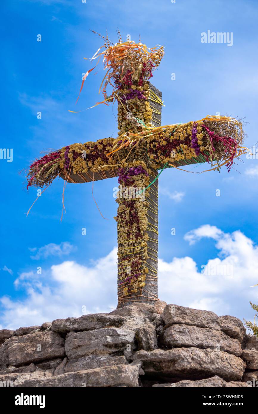 Cross with colorful flowers at Mirador del Condor in Colca Canyon Peru ...