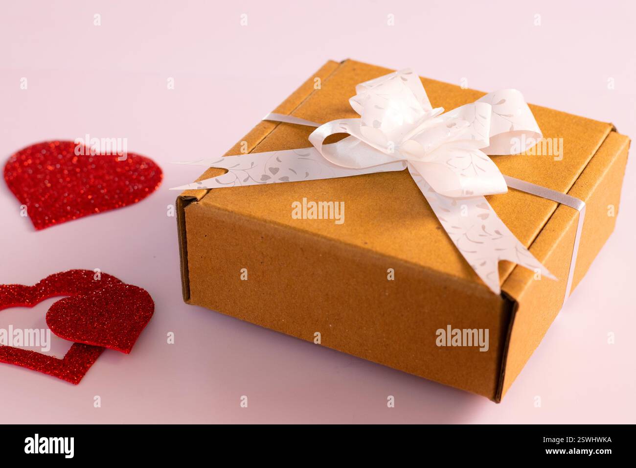 Red colored heart template taken out from the red glittering sheet with ...