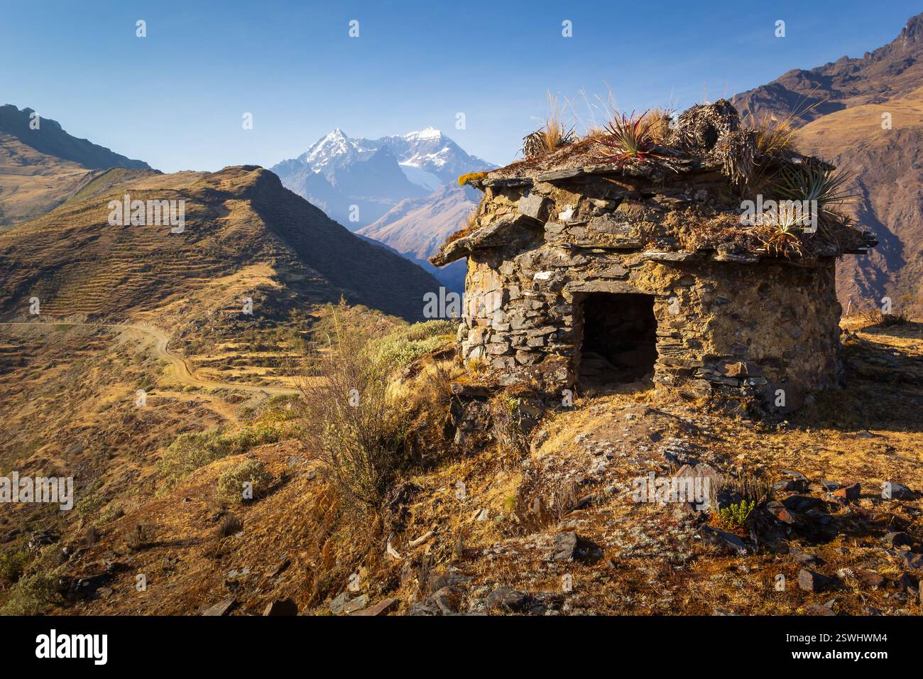 A small circular stone tower on top of a high mountain near Lares ...