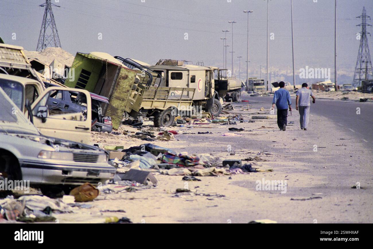 First Gulf War: 1st April 1991 Two local men walk past an assortment of ...