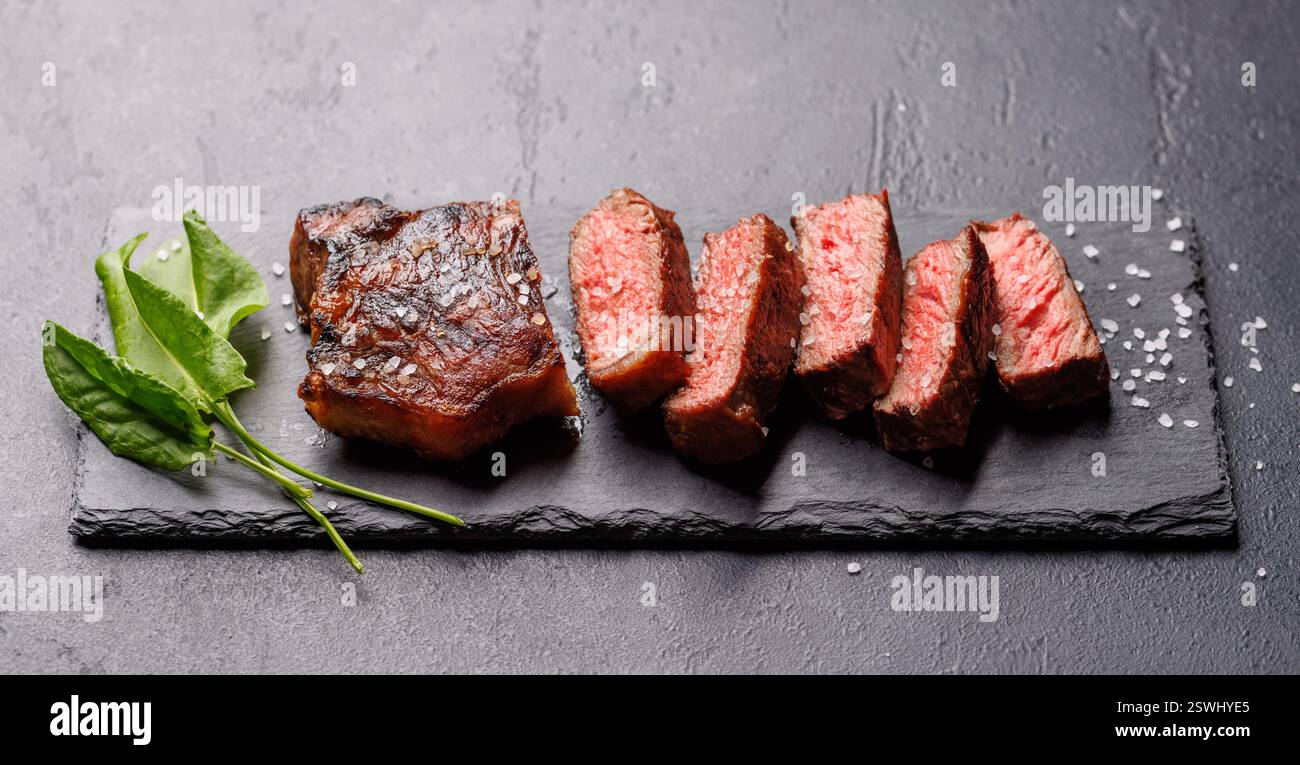 A perfectly cooked sliced striploin steak with a juicy, tender texture ...