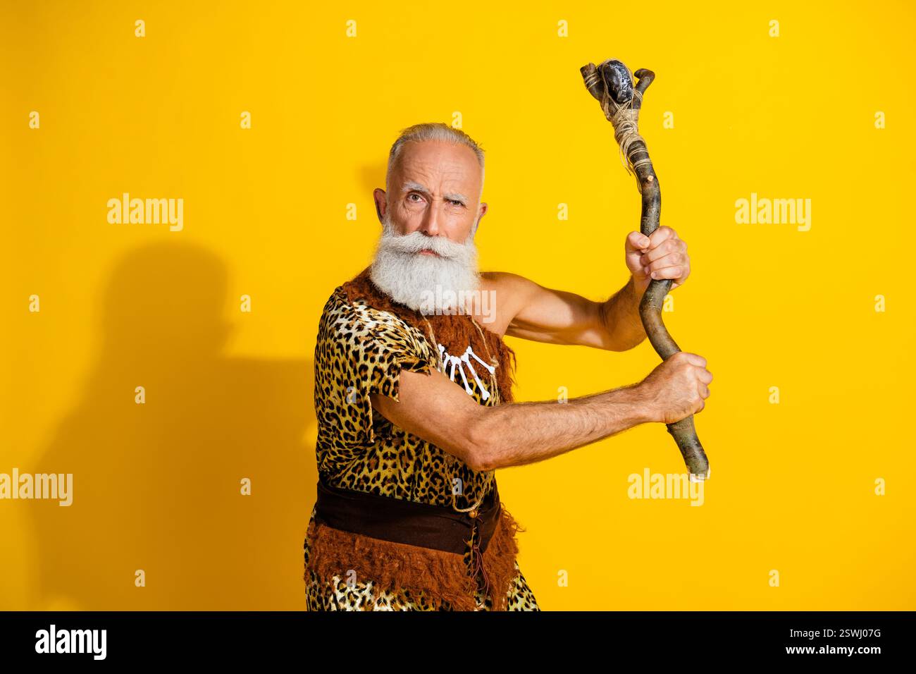 Photo of ancient aged caveman hold stone ax wear leopard skin clothes ...