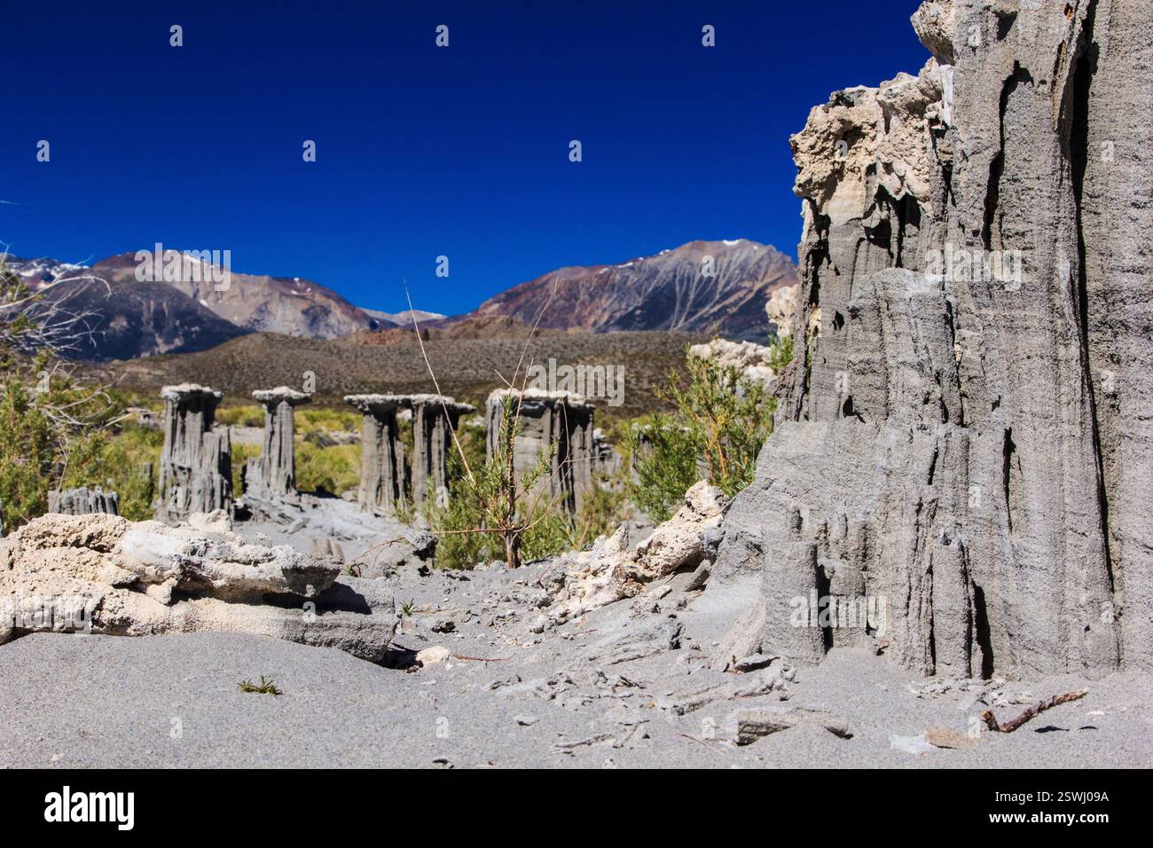 Rocky mountain range with a clear blue sky. The mountains are covered ...