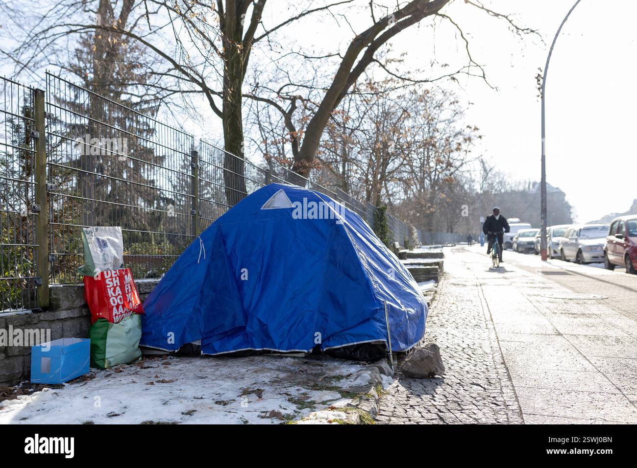 A self-made shelter for a homeless person on the side of the sidewalk ...
