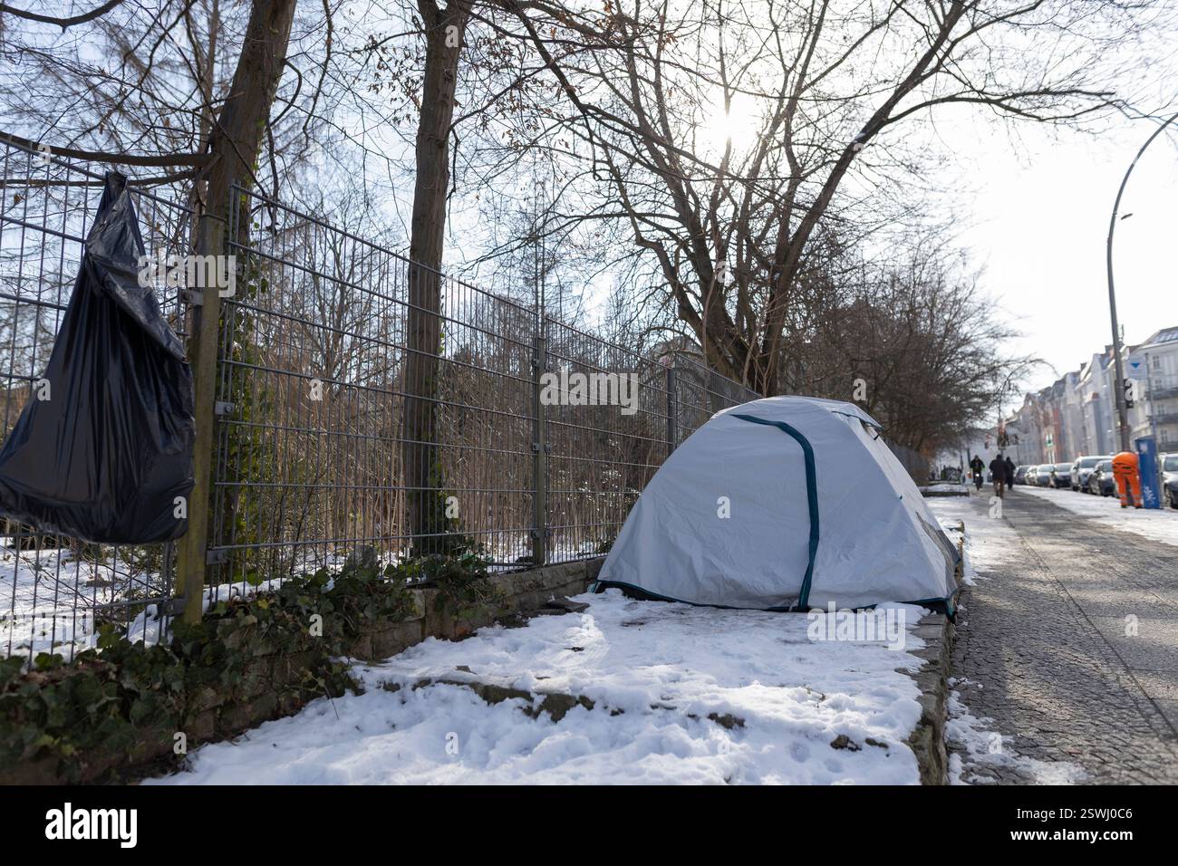 A self-made shelter for a homeless person on the side of the sidewalk ...