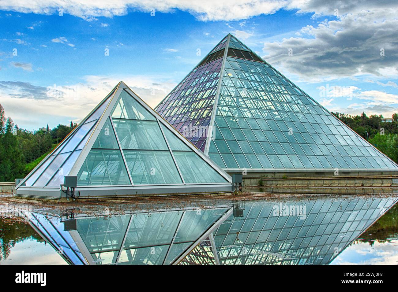 Large glass pyramid building with a glass roof. The building is ...