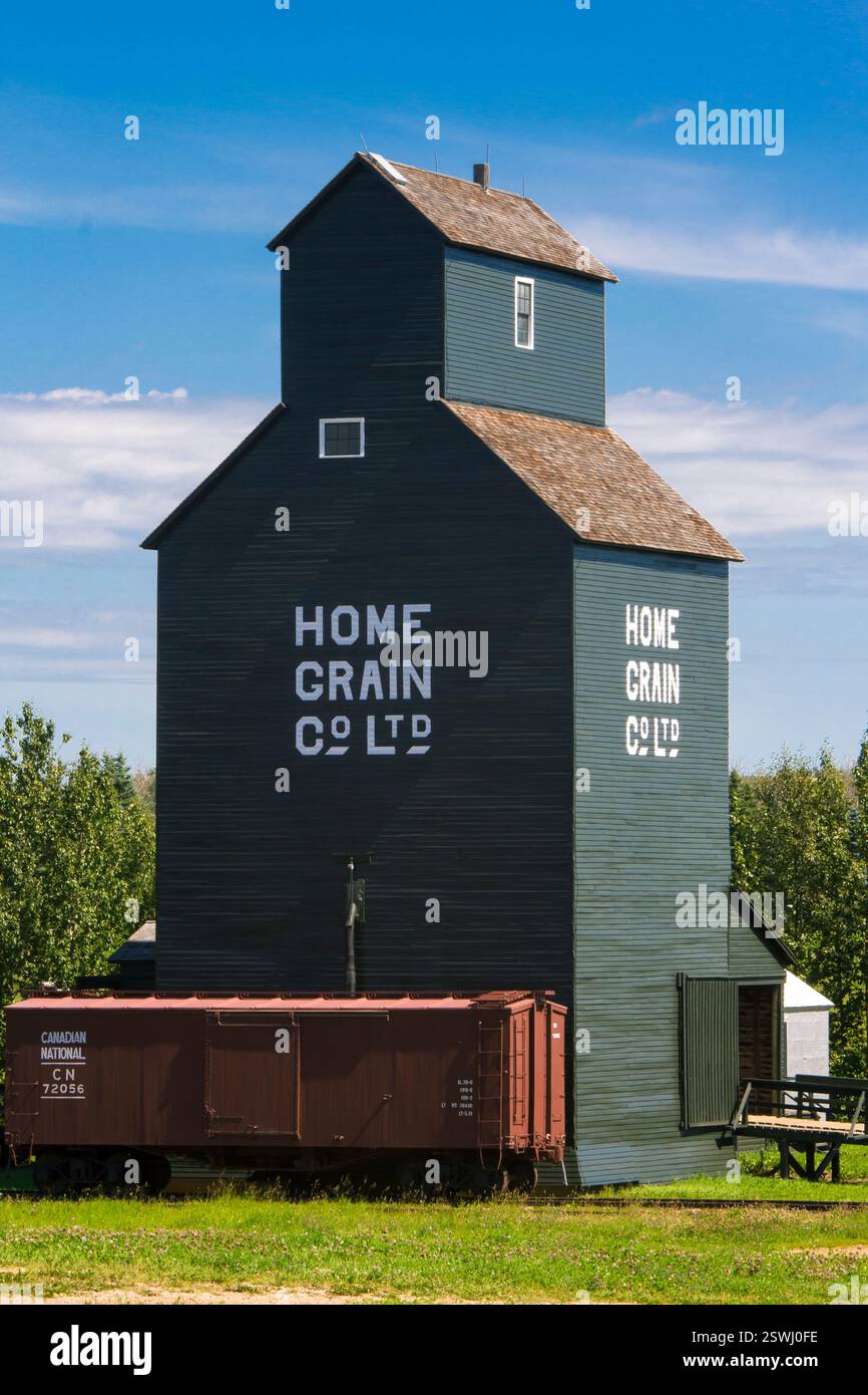 Large grain silo with the words Home Grain Co. Ltd. On it. The silo is ...