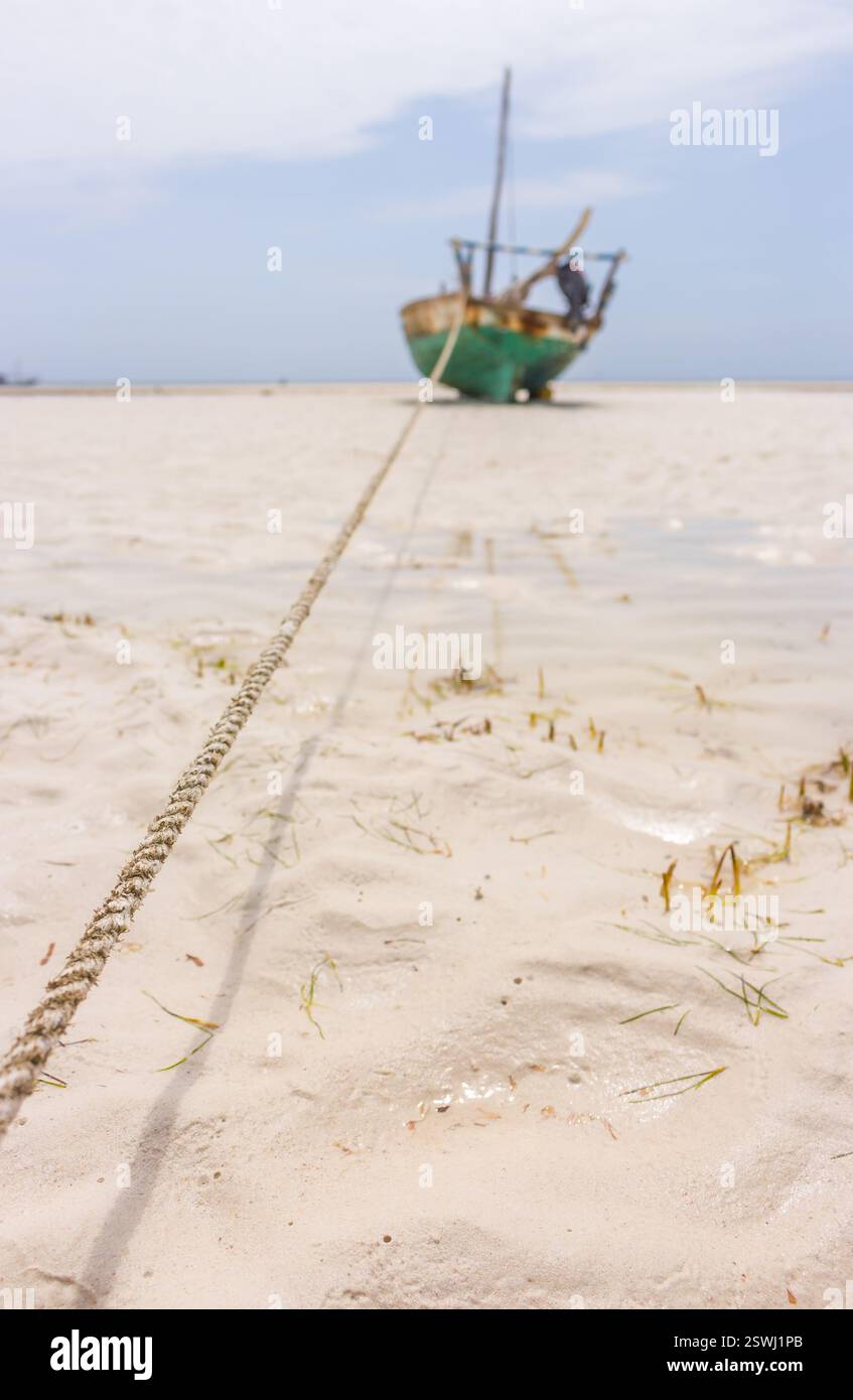 Rusty boat anchored at the beach. Tropical low tide landscape with ...