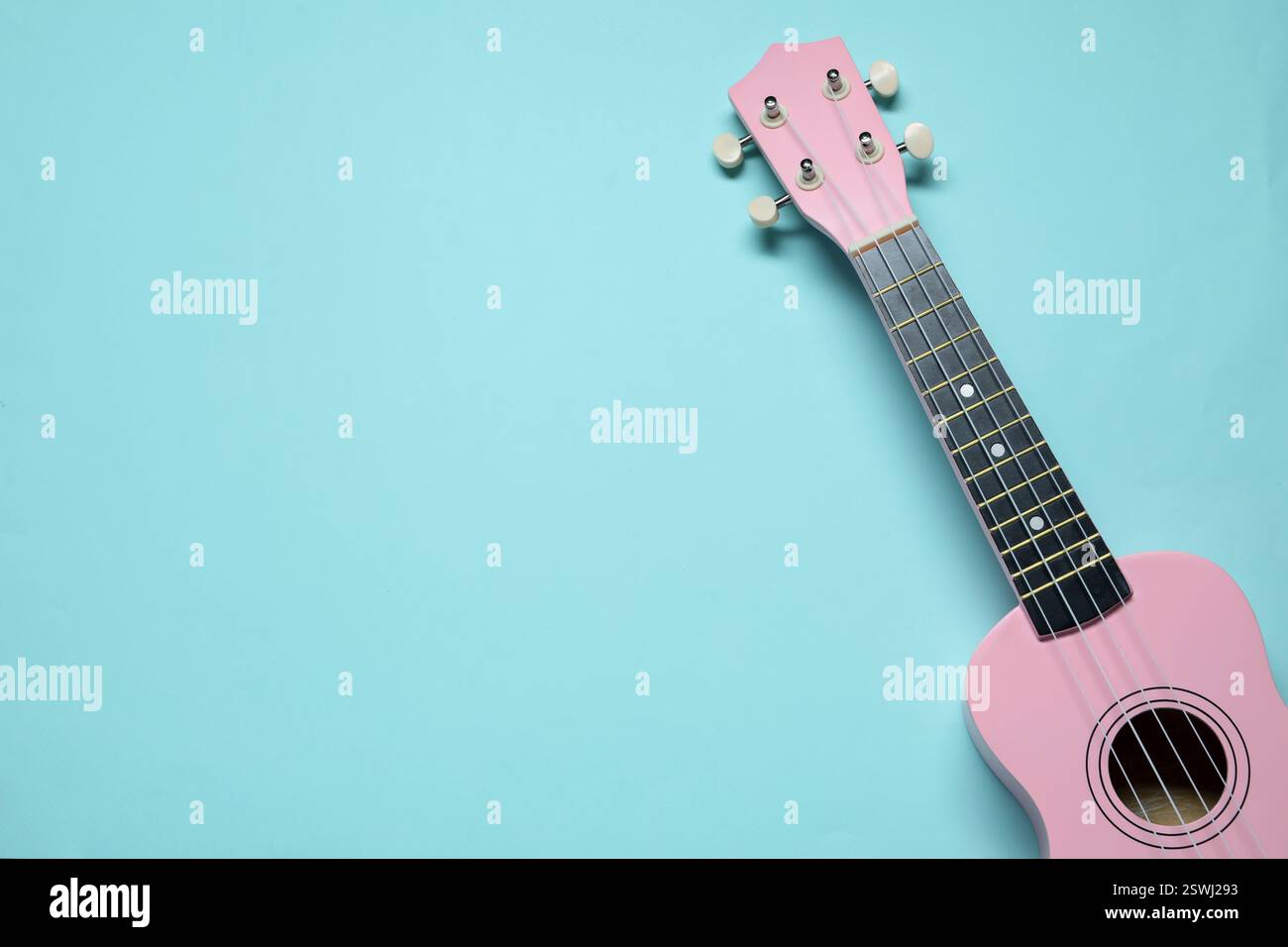 One ukulele on light blue background, top view. Space for text Stock ...