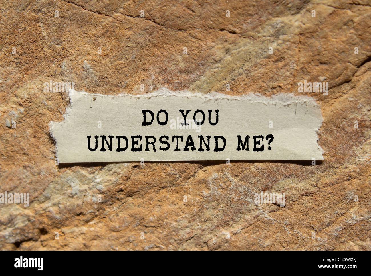 Do you understand me message written on ripped torn paper on stone ...