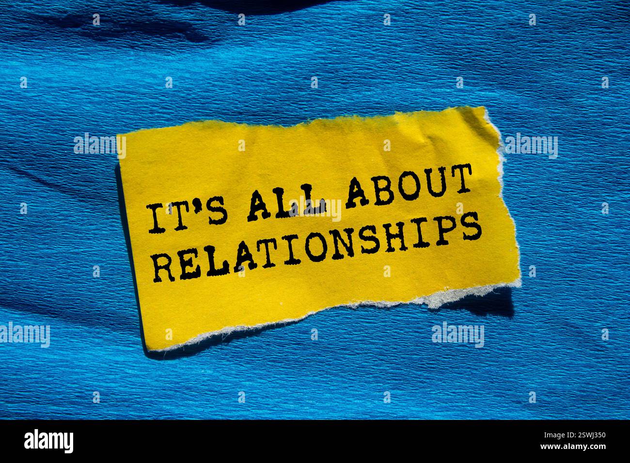 It’s all about relationships message written on ripped torn yellow ...