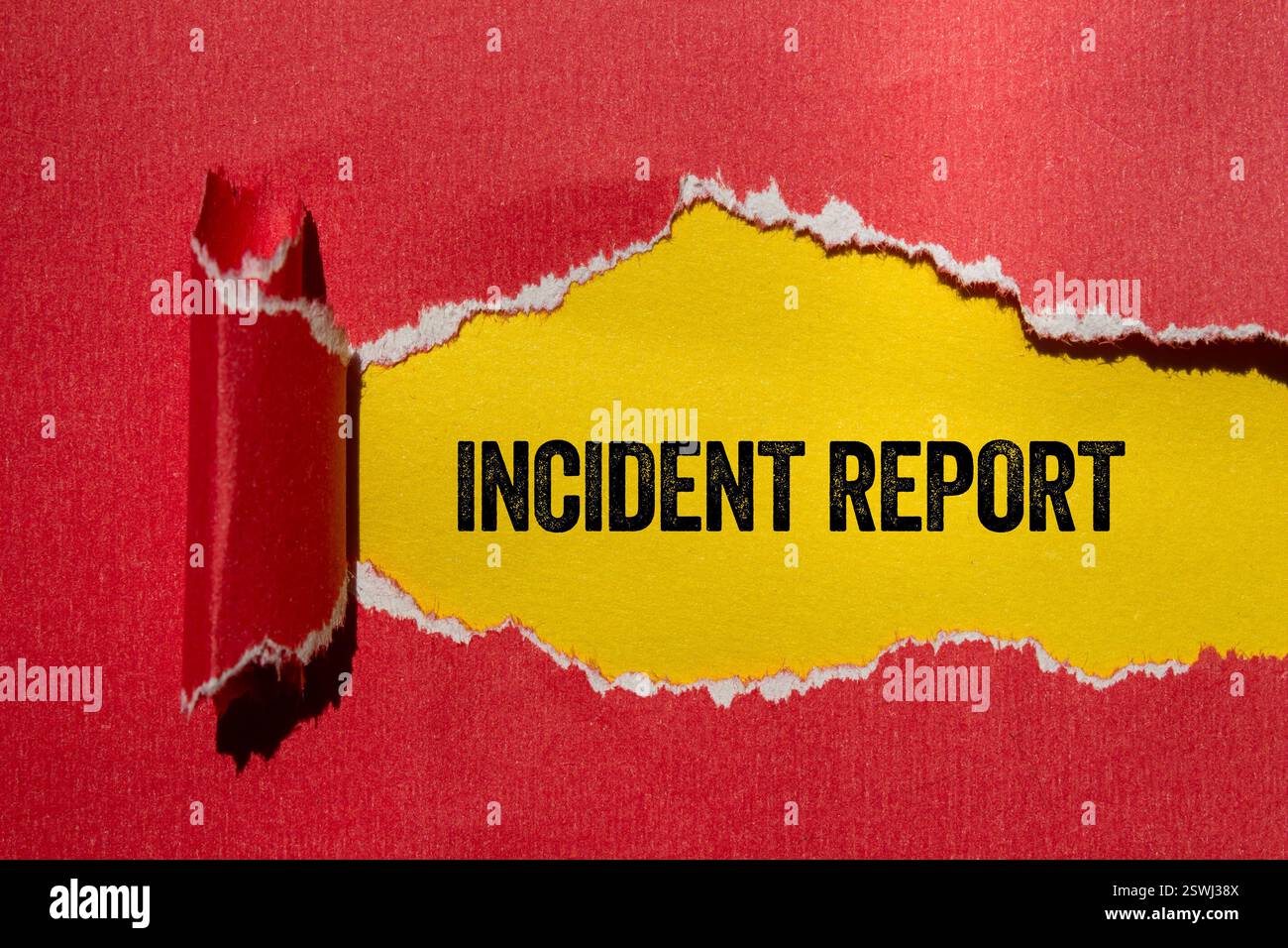 Incident report written on ripped torn red paper on yellow background ...