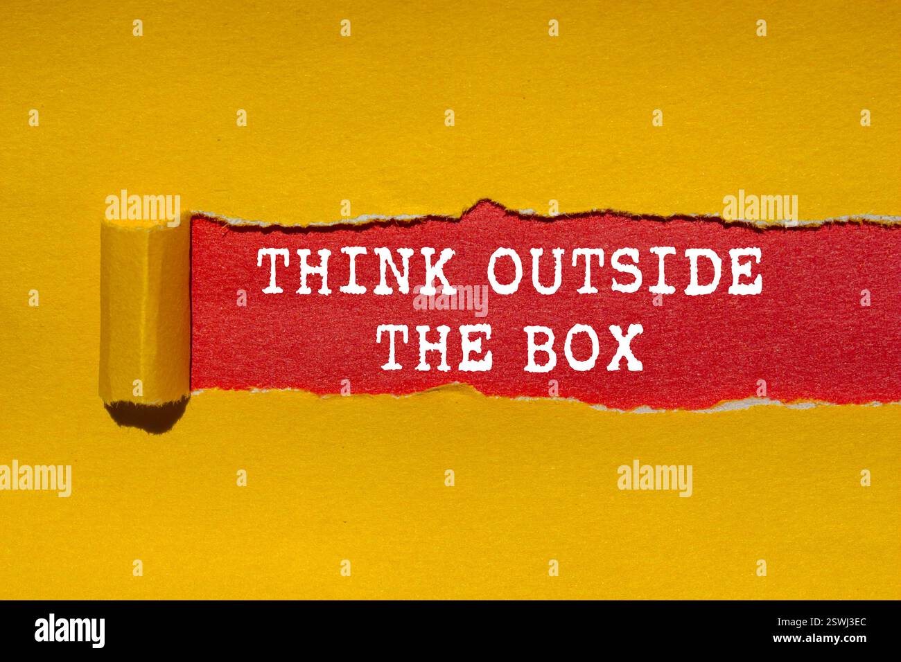 Think outside the box message written on ripped torn yellow paper on red background. Conceptual ...
