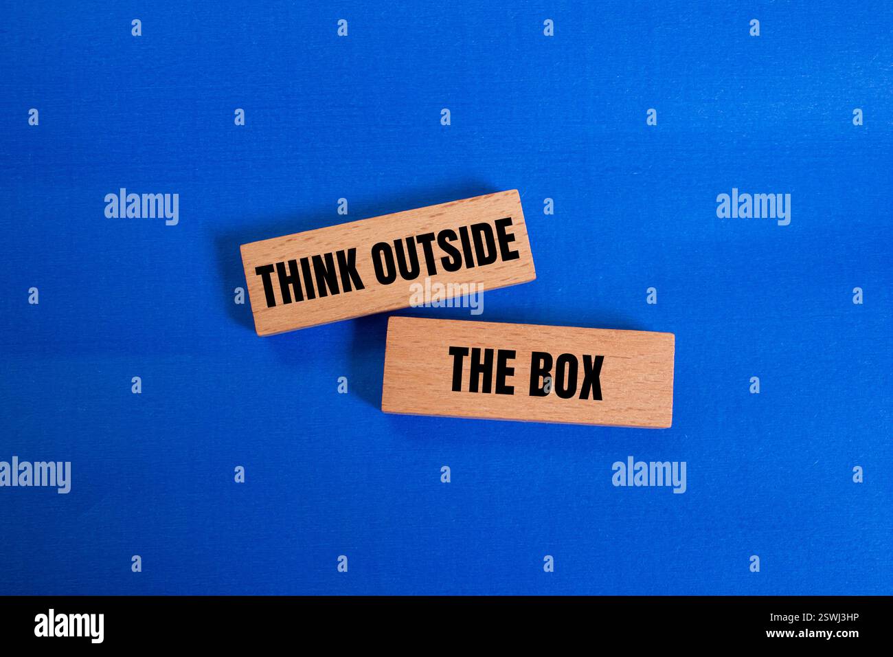 Think outside the box message written on wooden blocks on blue ...