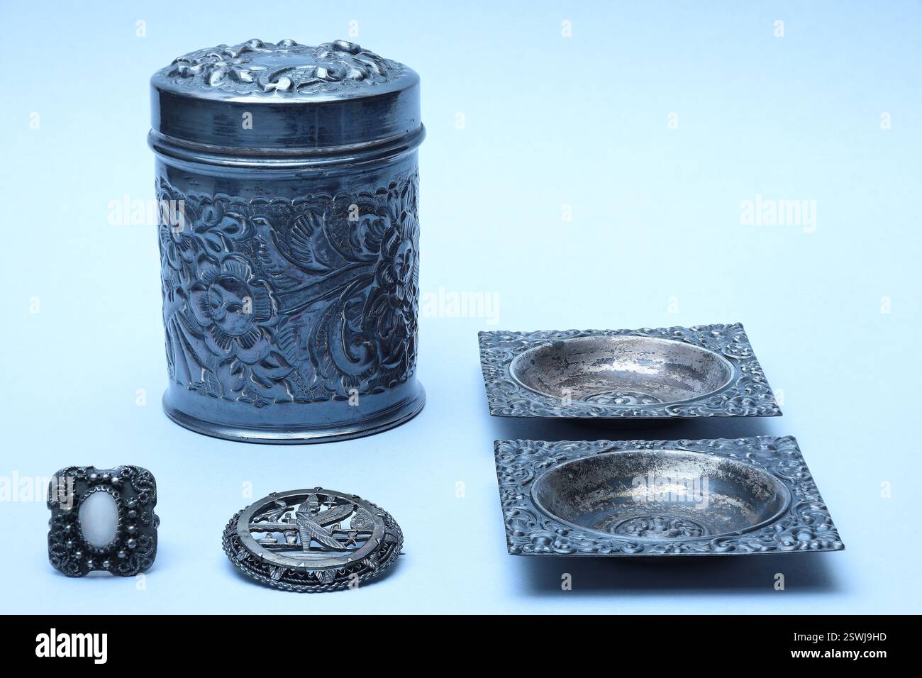 Still life with commonly used objects: brooch with ancient Egyptian ...