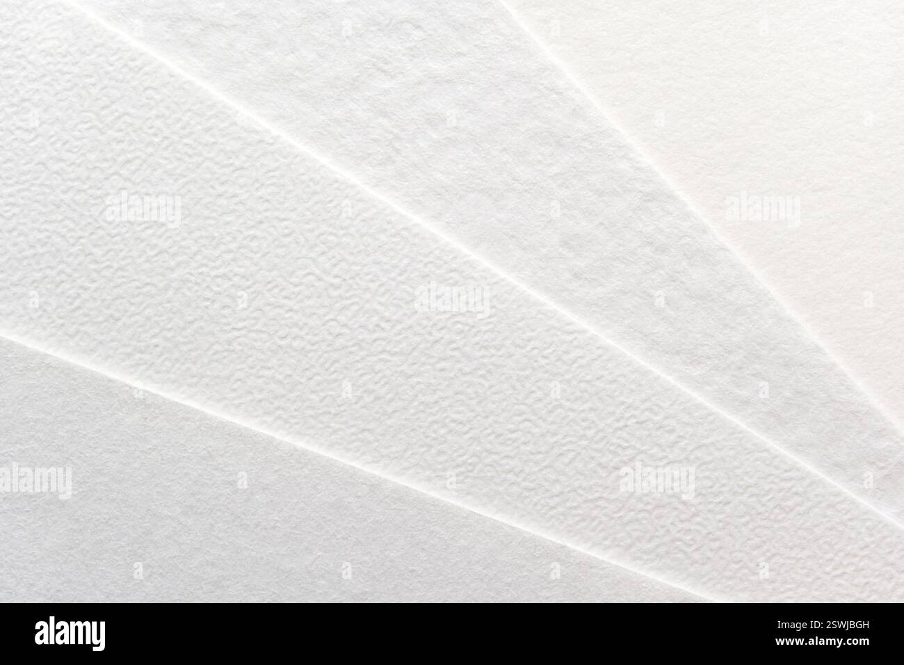 Close-up of textured white paper sheets arranged in a fan pattern Stock ...