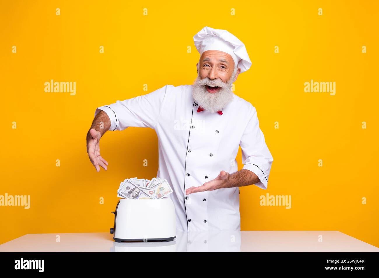 Senior chef joyfully presenting cash in a toaster against a vibrant ...