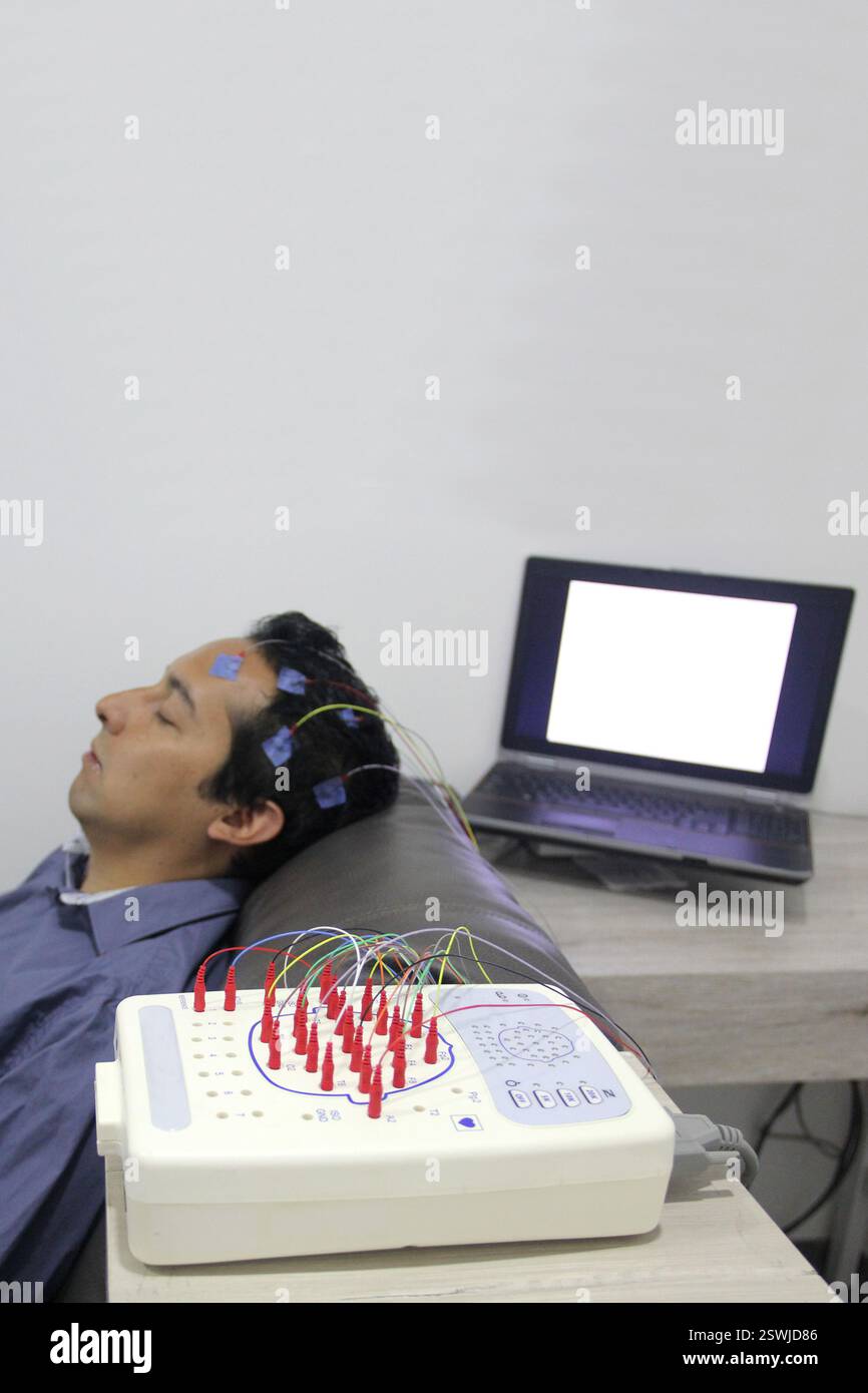 Electroencephalogram EEG in adult Latino man with wires in his head ...