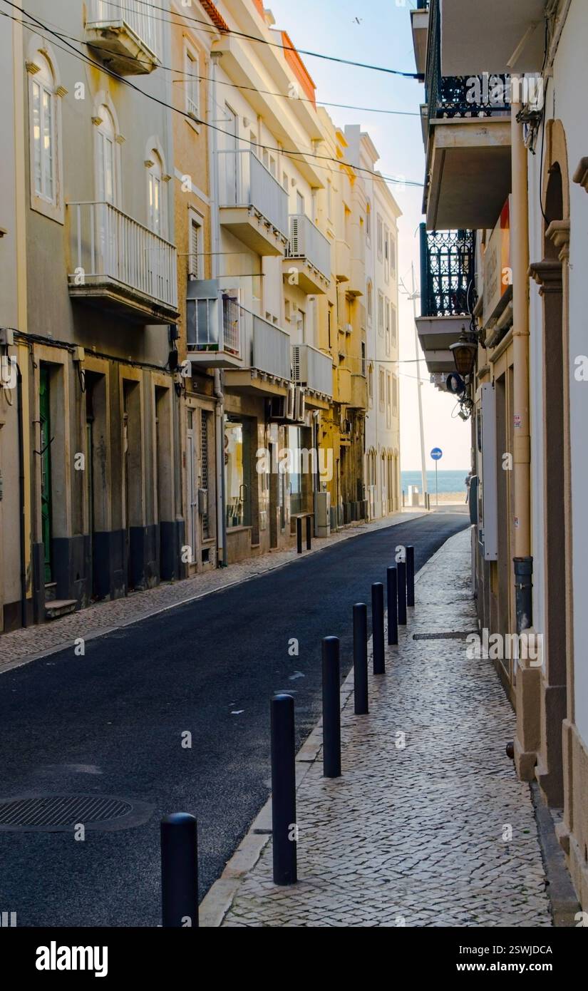 The narrow and pretty street leads to the ocean Stock Photo - Alamy