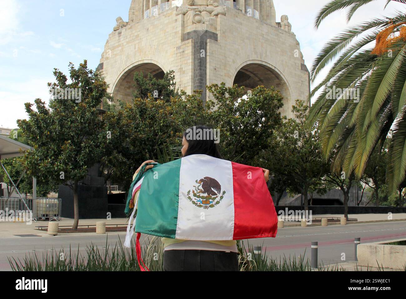 Latina adult woman shows the flag of Mexico with pride to celebrate the ...