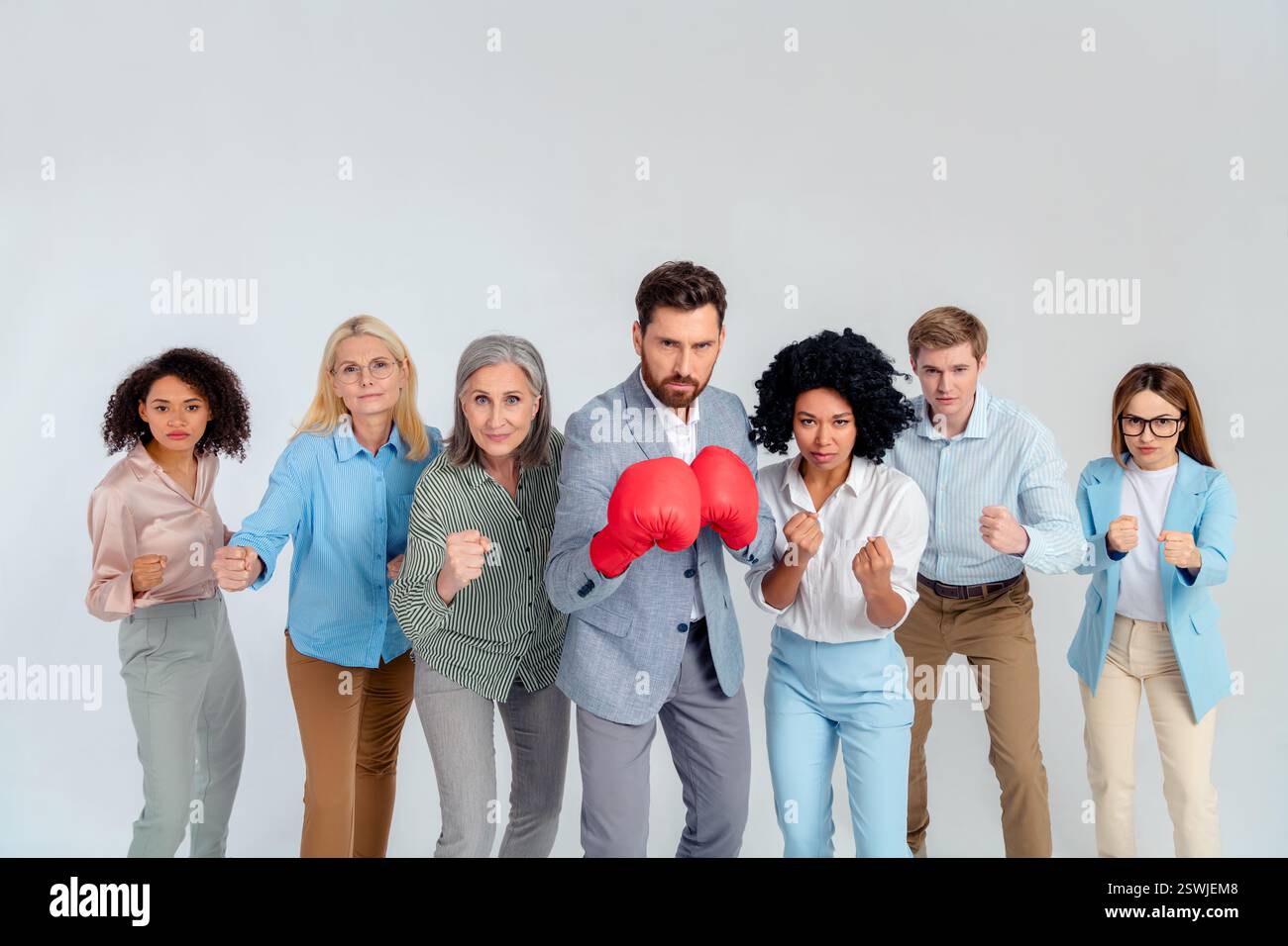 Diverse group of professionals in formal attire striking determined ...
