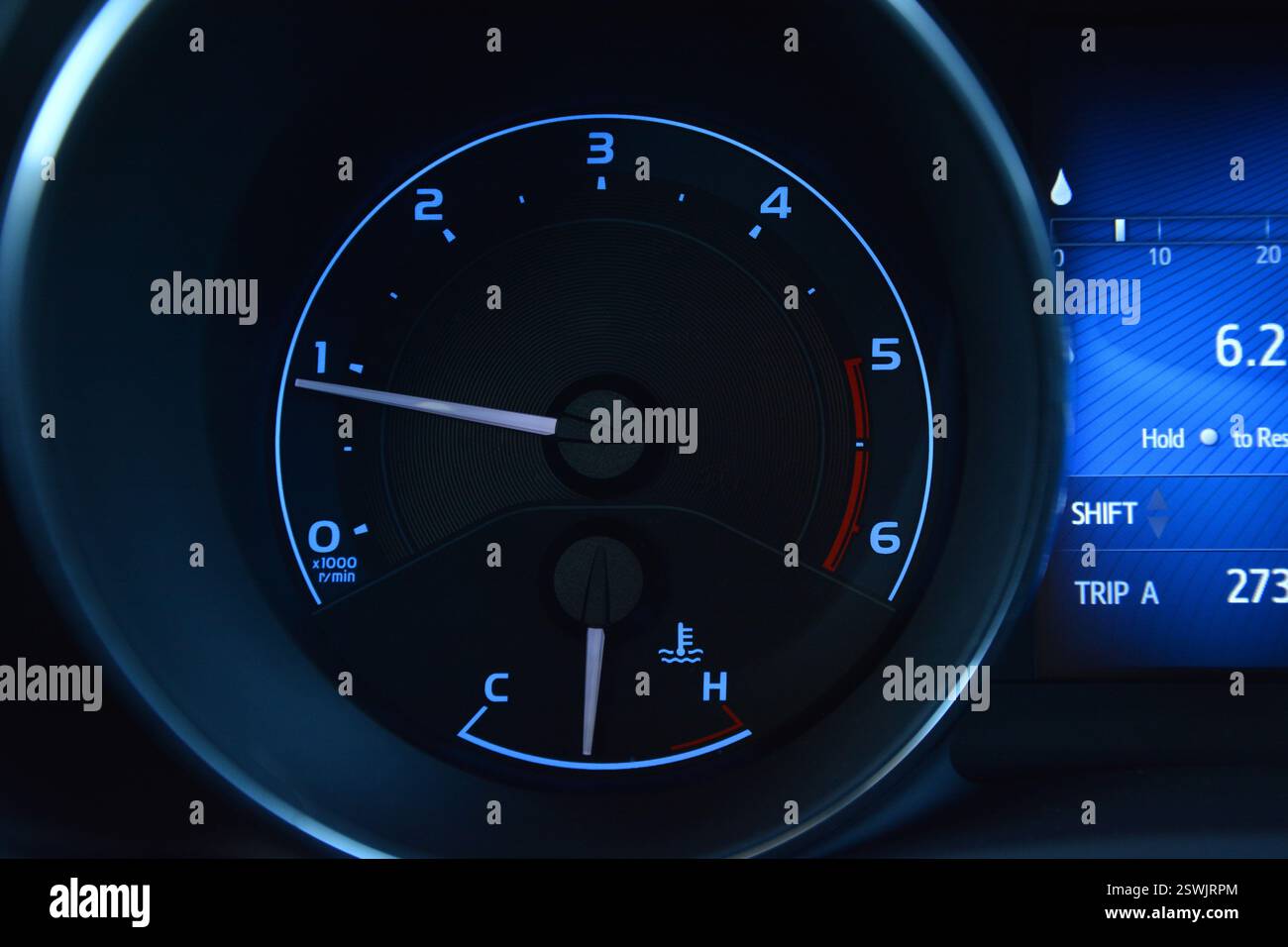 Close up of a car's instrument panel showing the tachometer speedometer ...