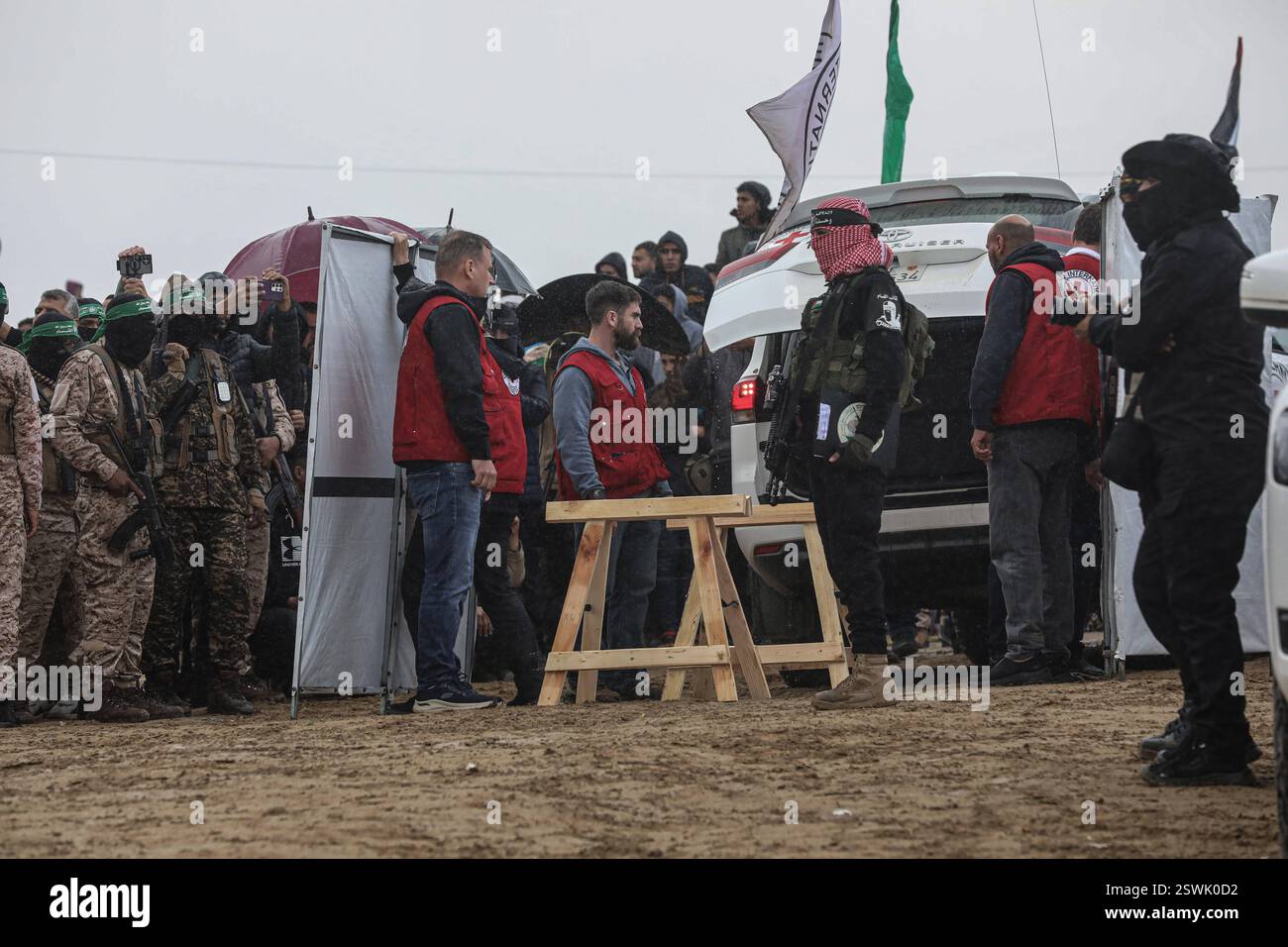 Members of the Al-Qassam Brigades, the military wing of Hamas, hand ...