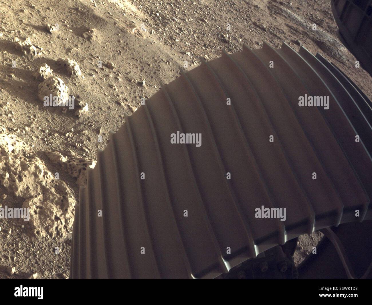 One of the six wheels aboard the Perseverance Mars rover, which landed ...