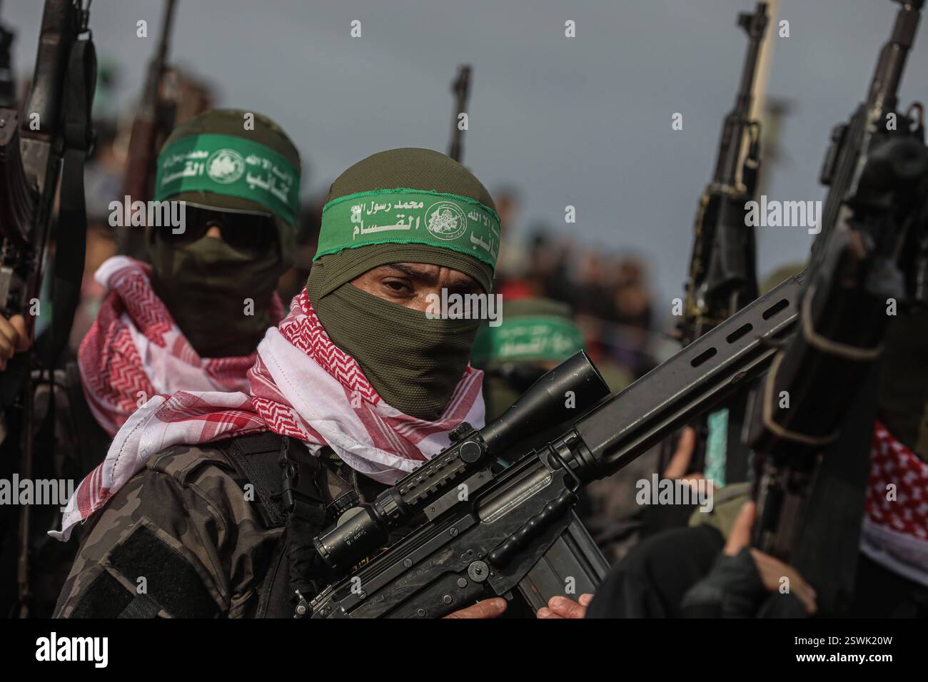 Members of the Al-Qassam Brigades, the military wing of Hamas, hand ...