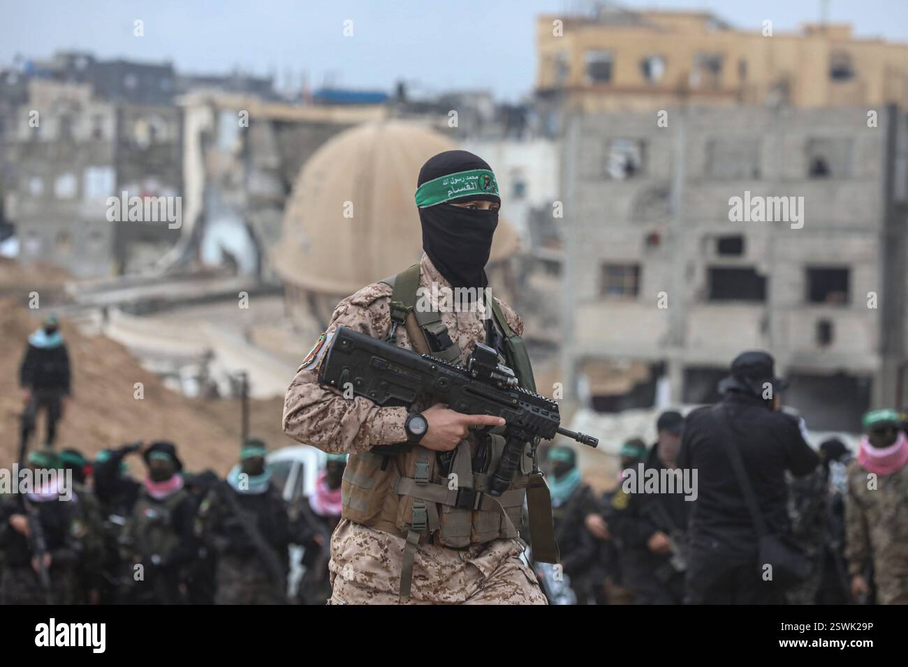Members of the Al-Qassam Brigades, the military wing of Hamas, hand ...