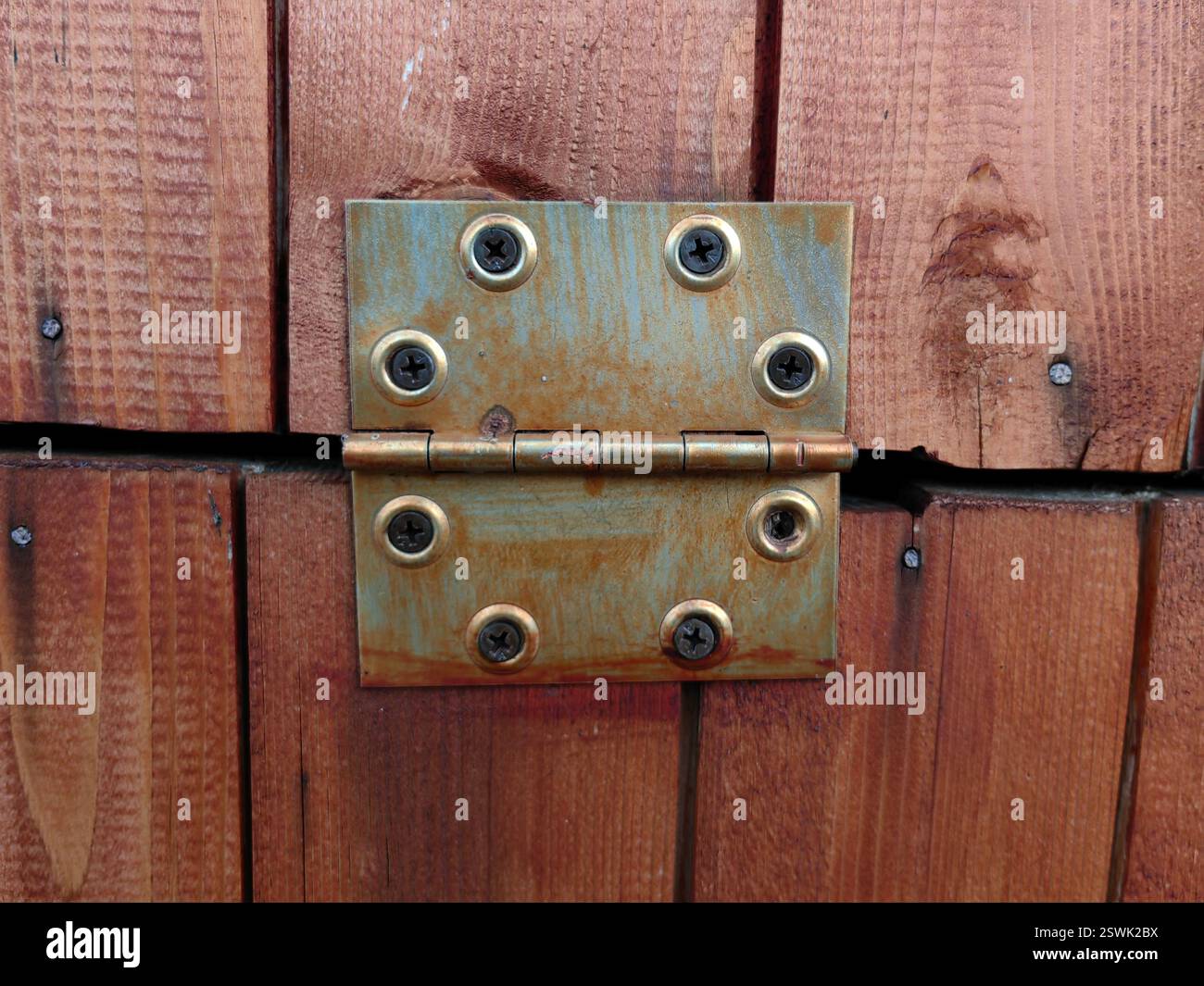 Golden Link: Metal Hinge & Wooden Connection Stock Photo - Alamy