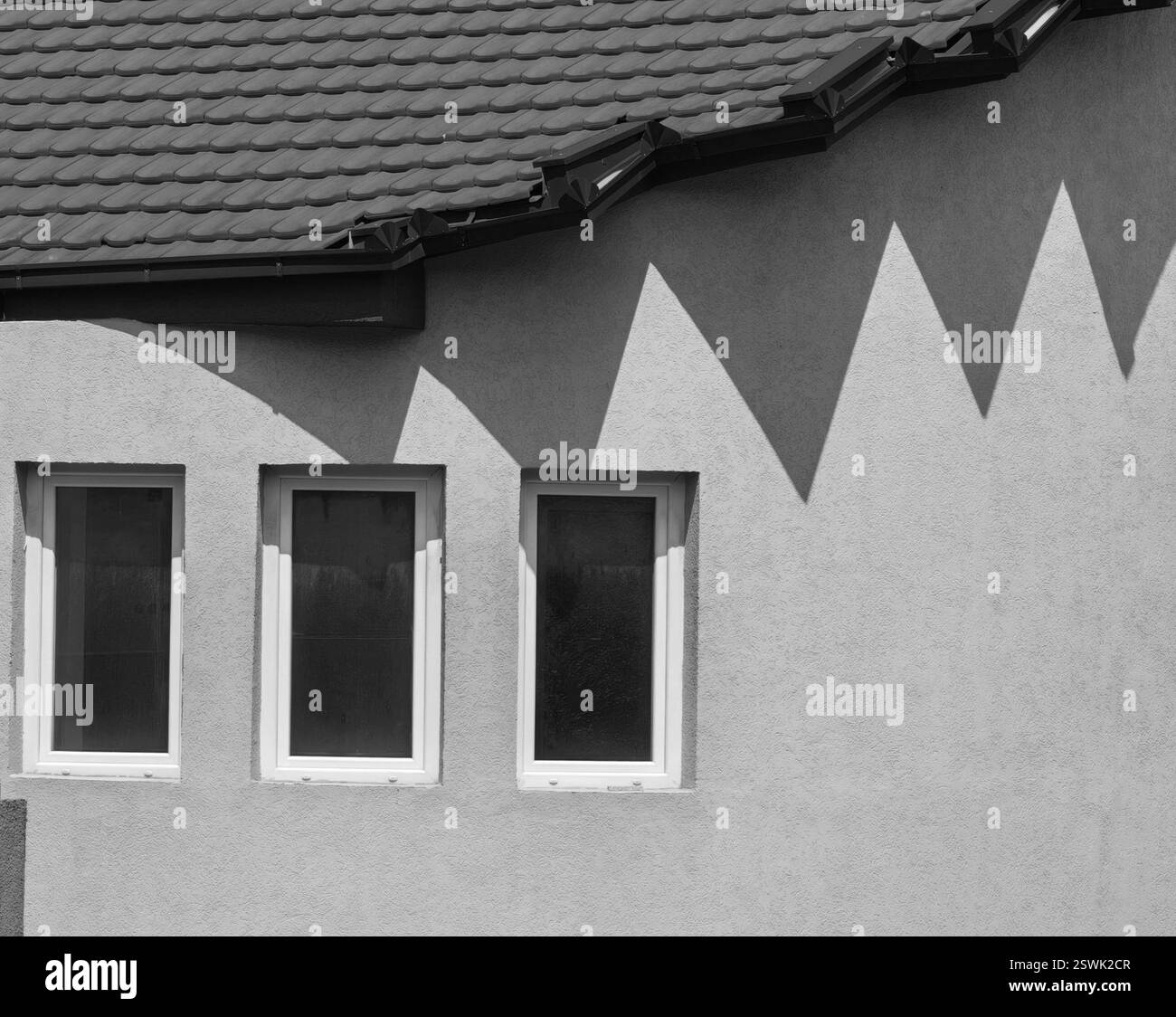 Three Windows and Spiked Shadows Stock Photo - Alamy