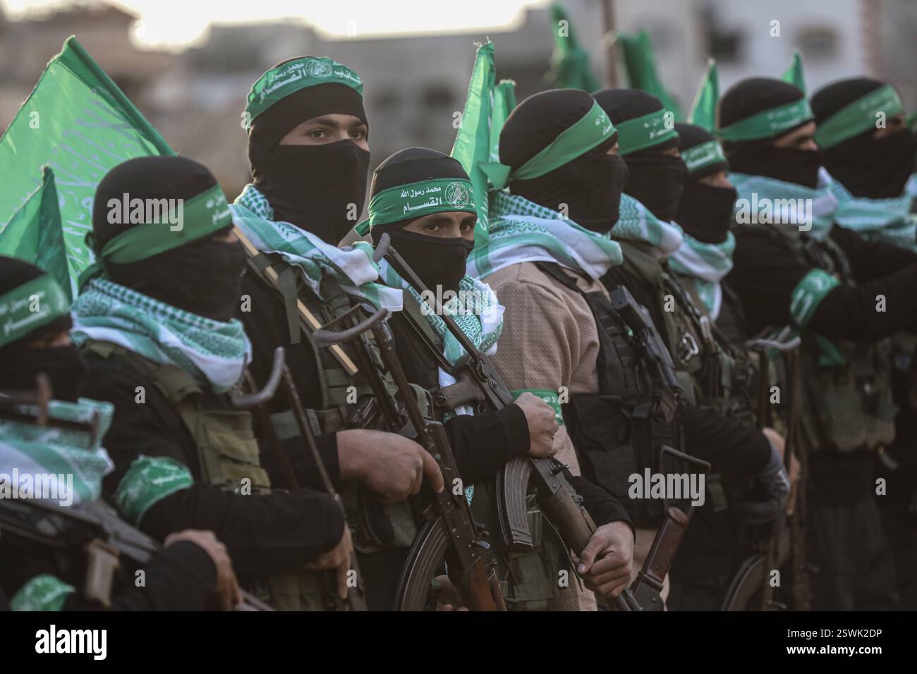 Members of the Al-Qassam Brigades, the military wing of Hamas, hand ...