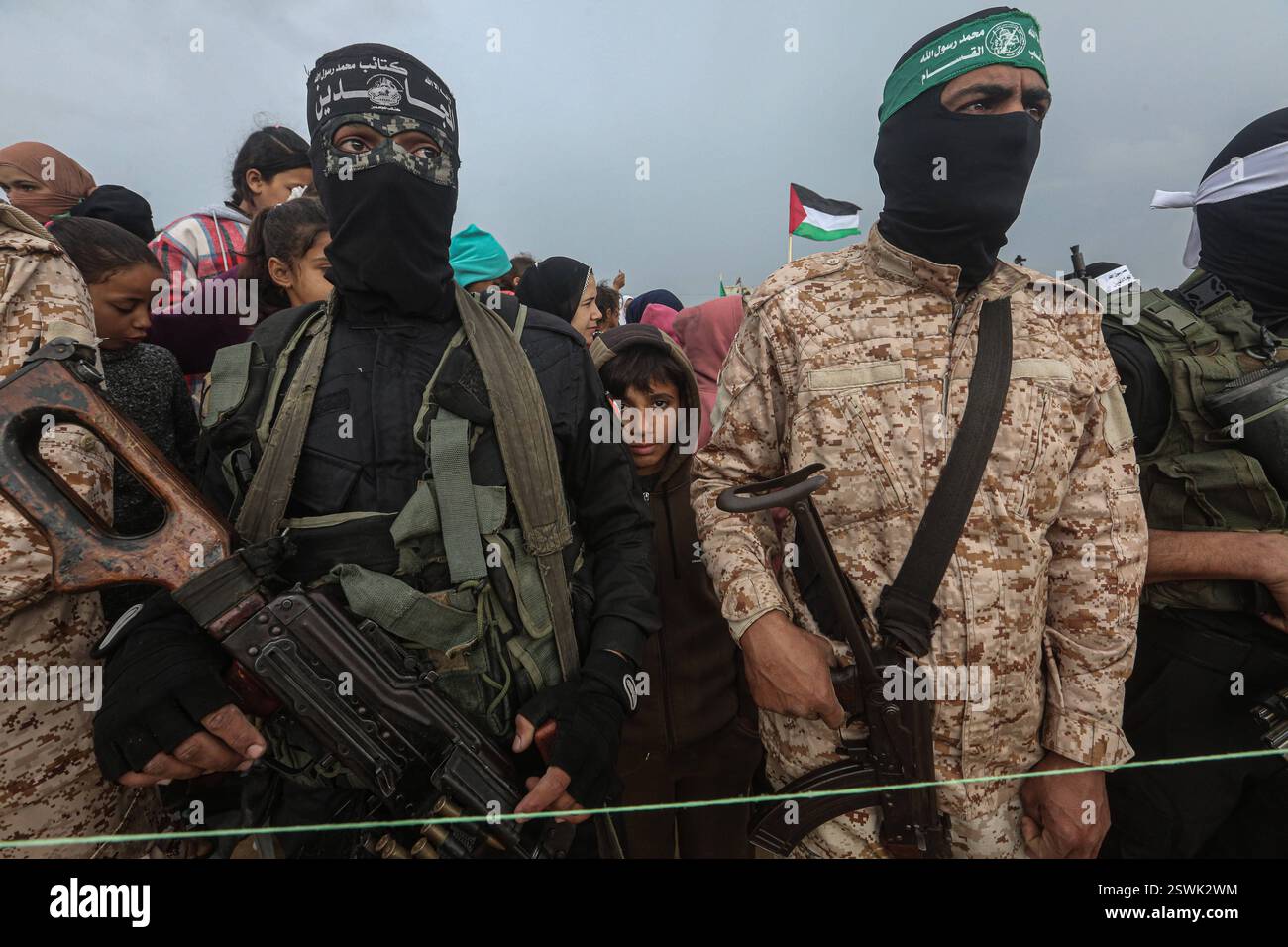 Members of the Al-Qassam Brigades, the military wing of Hamas, hand ...