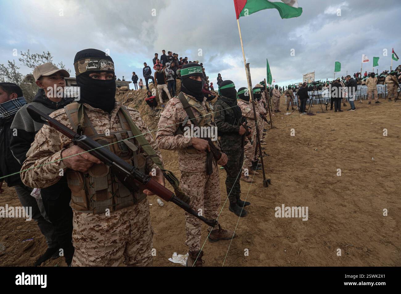 Members of the Al-Qassam Brigades, the military wing of Hamas, hand ...