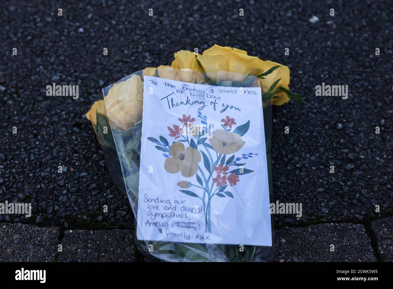A card and flowers are laid for Lilly Day to remember he sudden passing ...