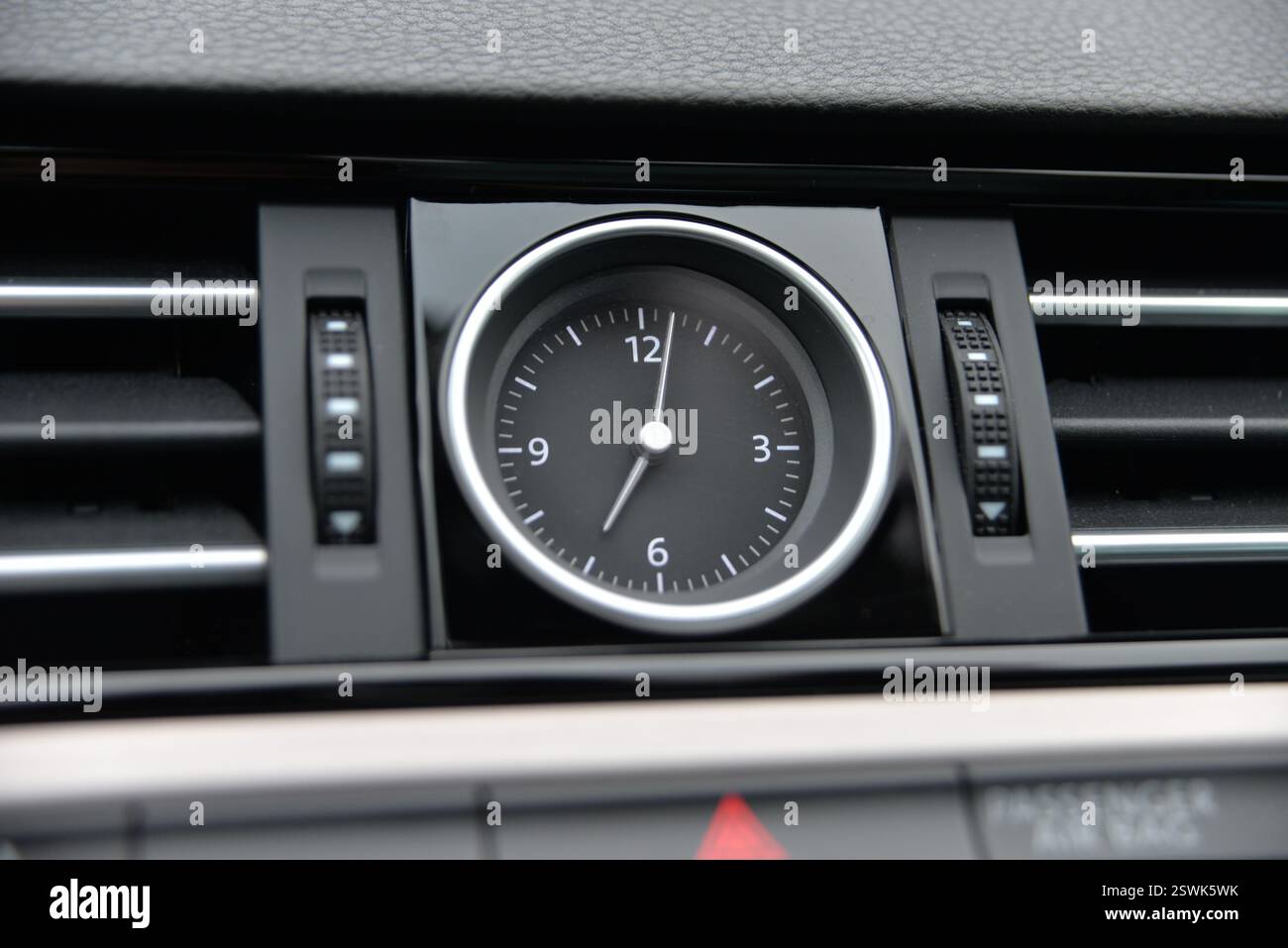 Close up of a car's dashboard clock and air vents Stock Photo - Alamy